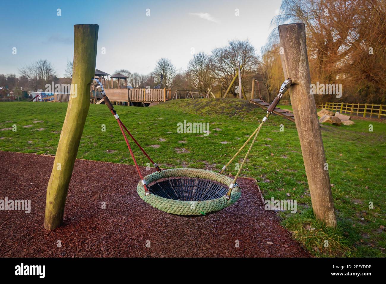 Birds nest children's play swing hanging from two wooden pole ...