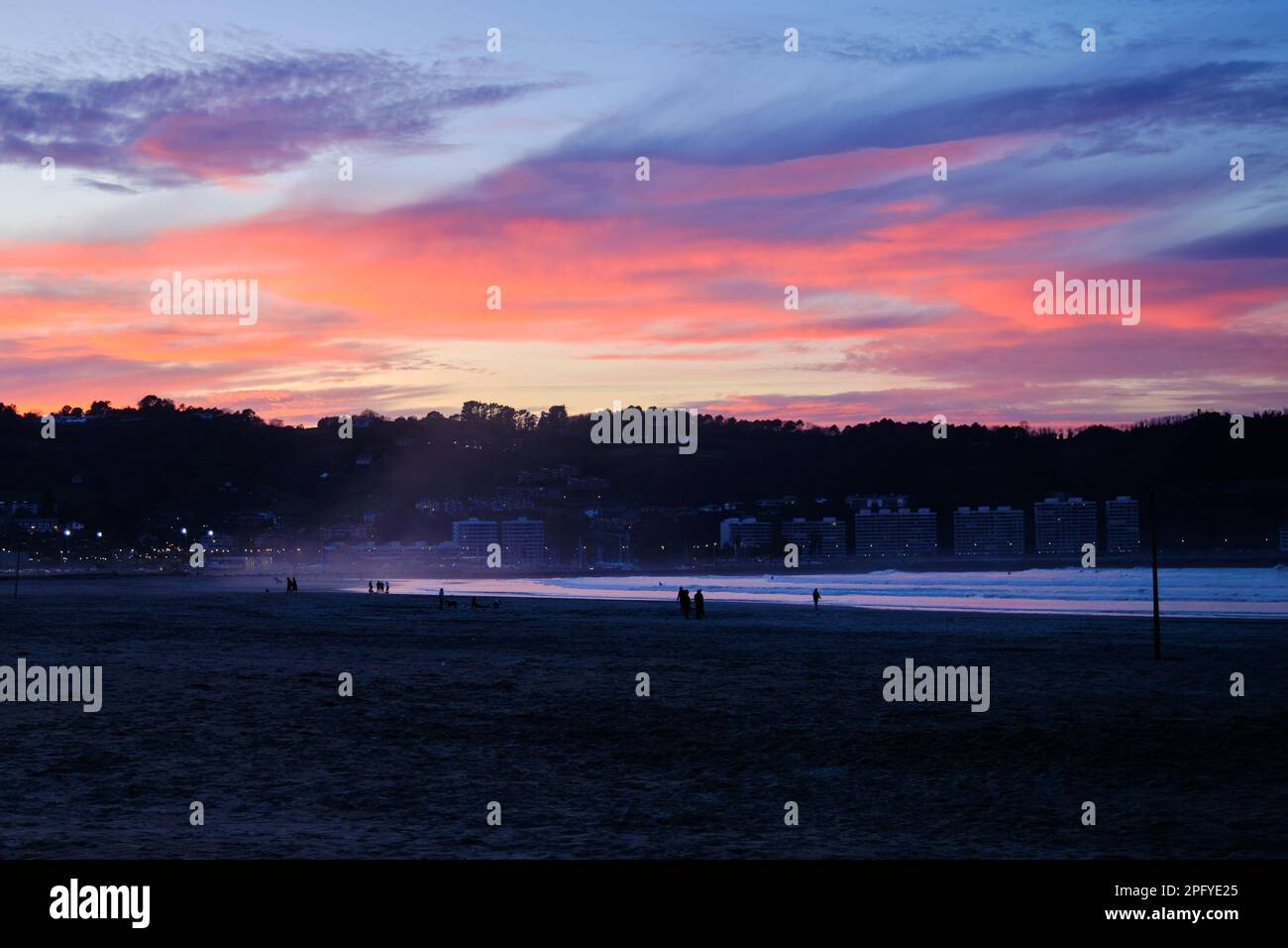 panorama of a sunset on the beach where you can see the red, orange and ...