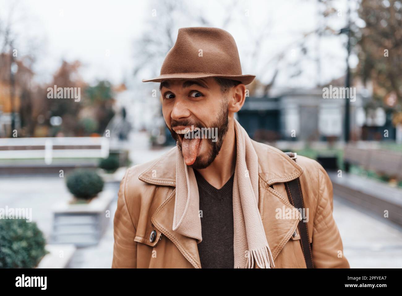 Portrait of young male model in fashionable clothes that is outdoors in ...
