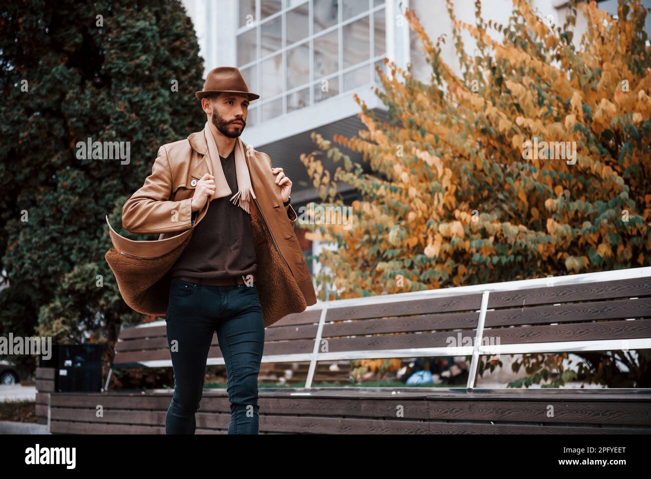 Young male model in fashionable clothes is outdoors in the city at ...