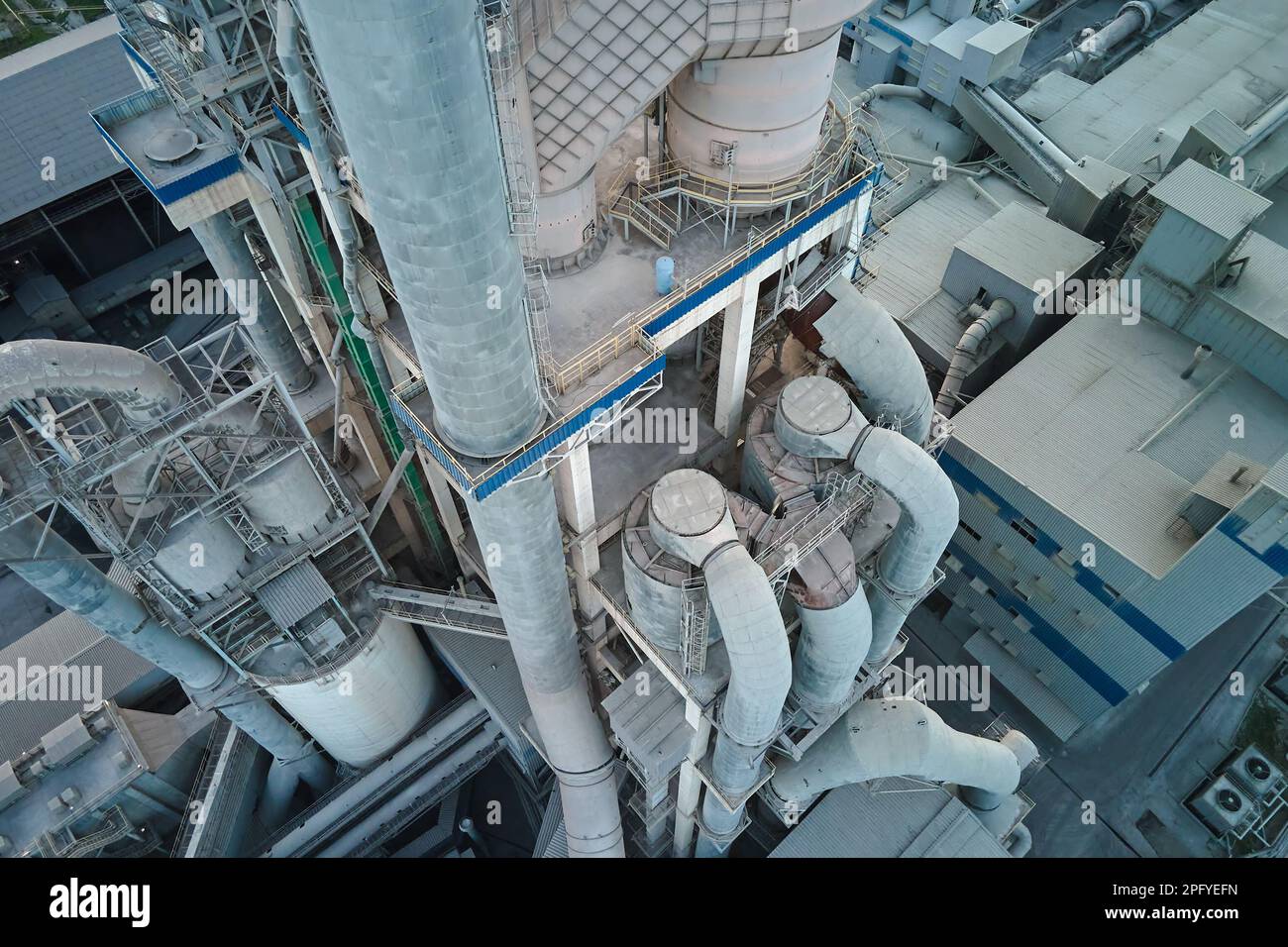 Cement plant with high factory structure and tower cranes at industrial ...