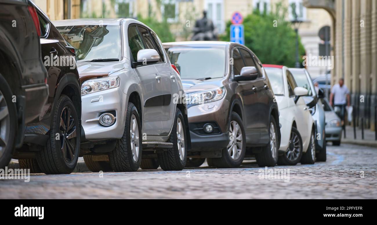 City traffic with cars parked in line on street side Stock Photo - Alamy