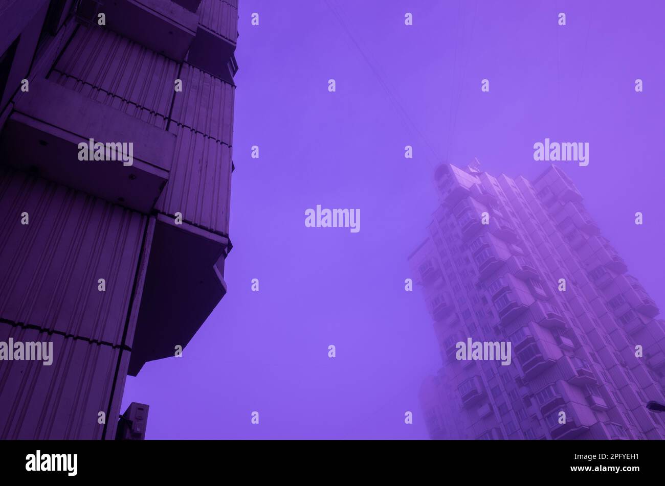 Tall residential buildings in the form of a tower, immersed in a misty ...