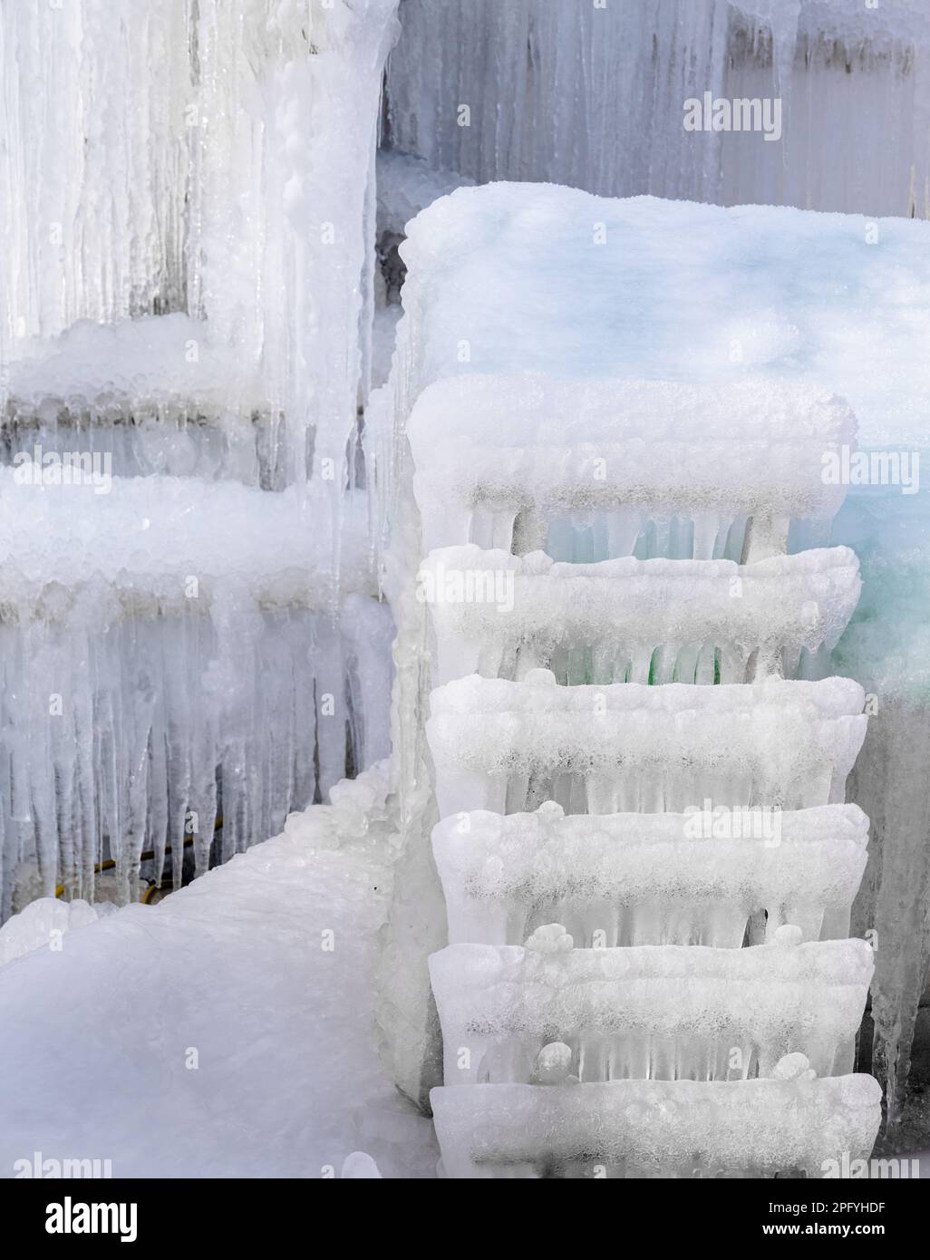 Winter climate and weather. Wooden ladder covered with frozen ice ...