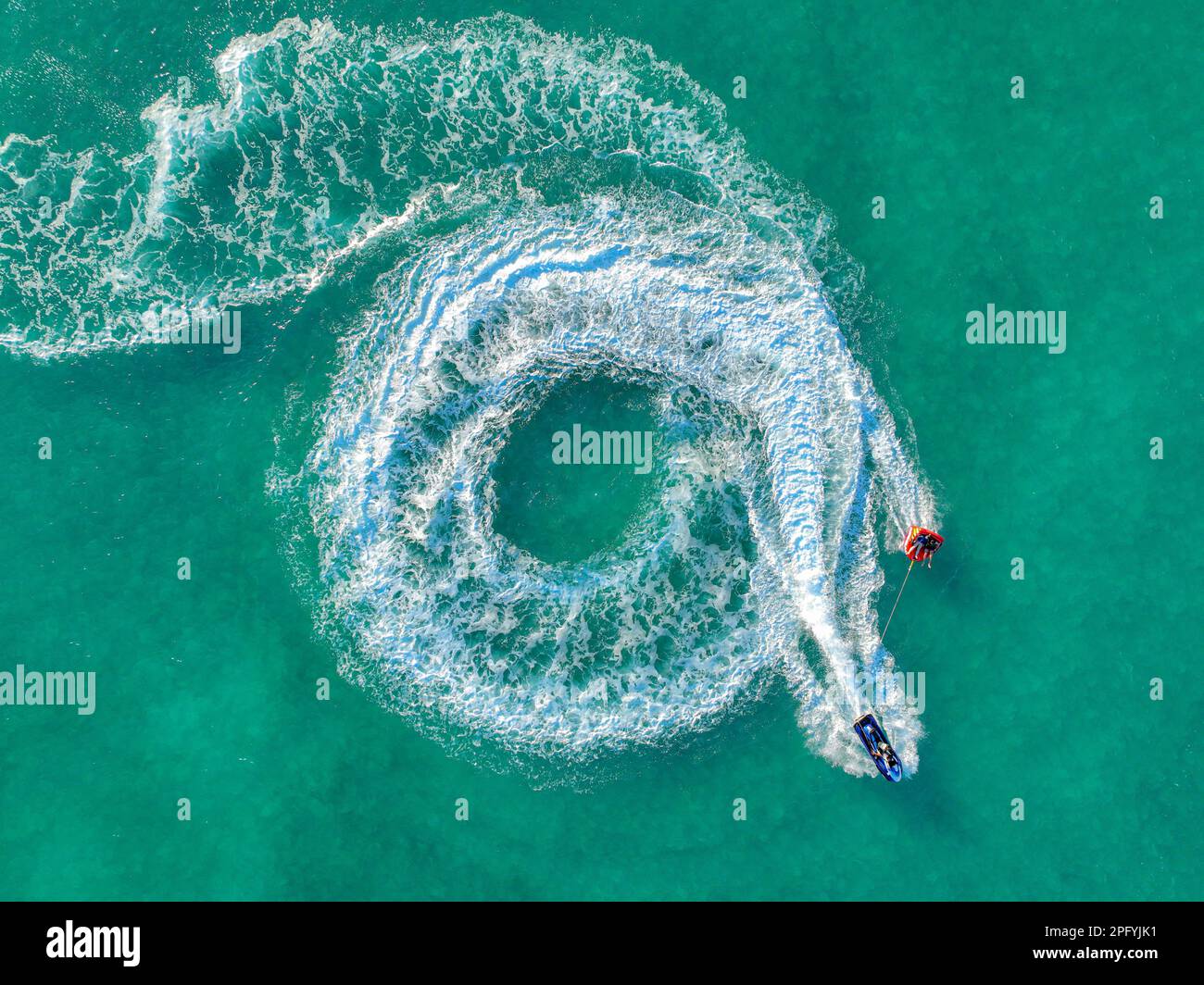 An aerial top view of a speed boat navigating the open ocean performing ...