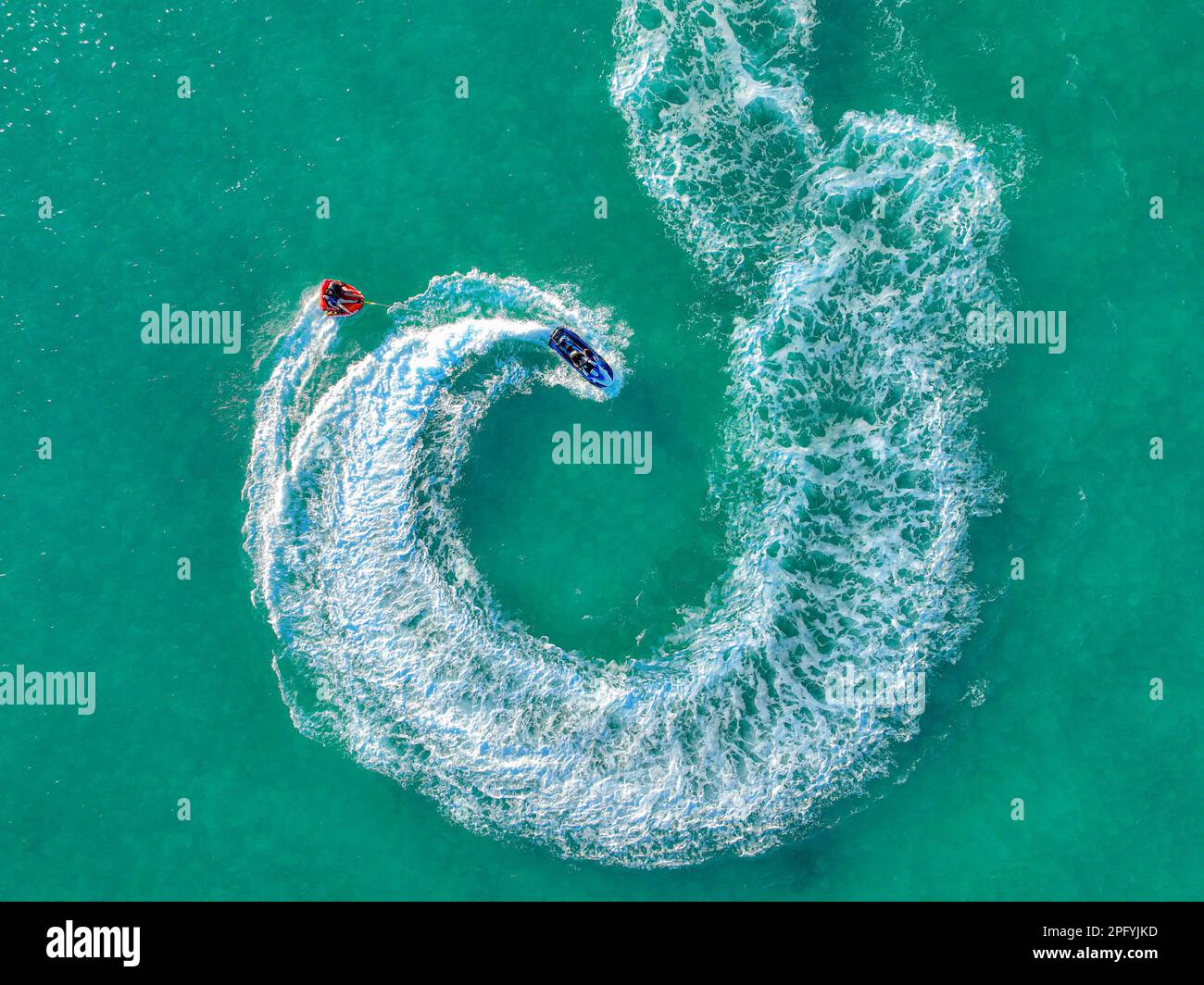 An aerial top view of a speed boat navigating the open ocean performing ...