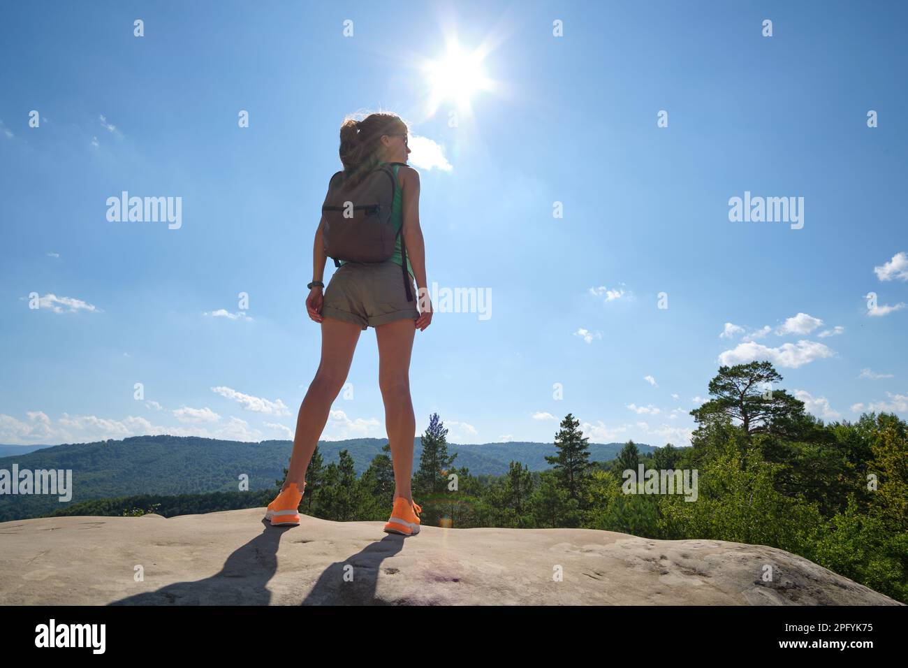 Hiker woman walking on mountain footpath enjoying summer nature. Lonely ...