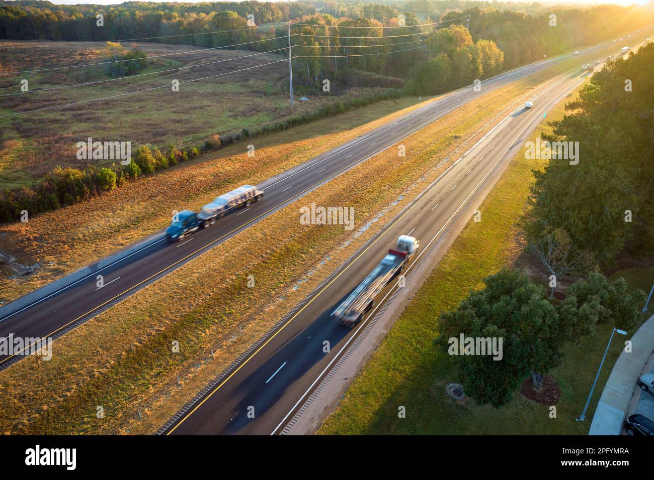 View from above of busy american highway with fast moving trucks and ...