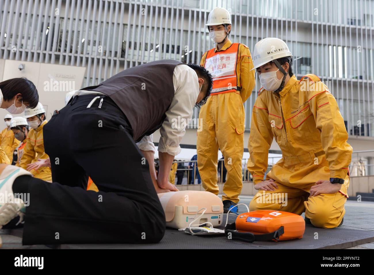A participant seen performing simulated first aid under supervision of ...