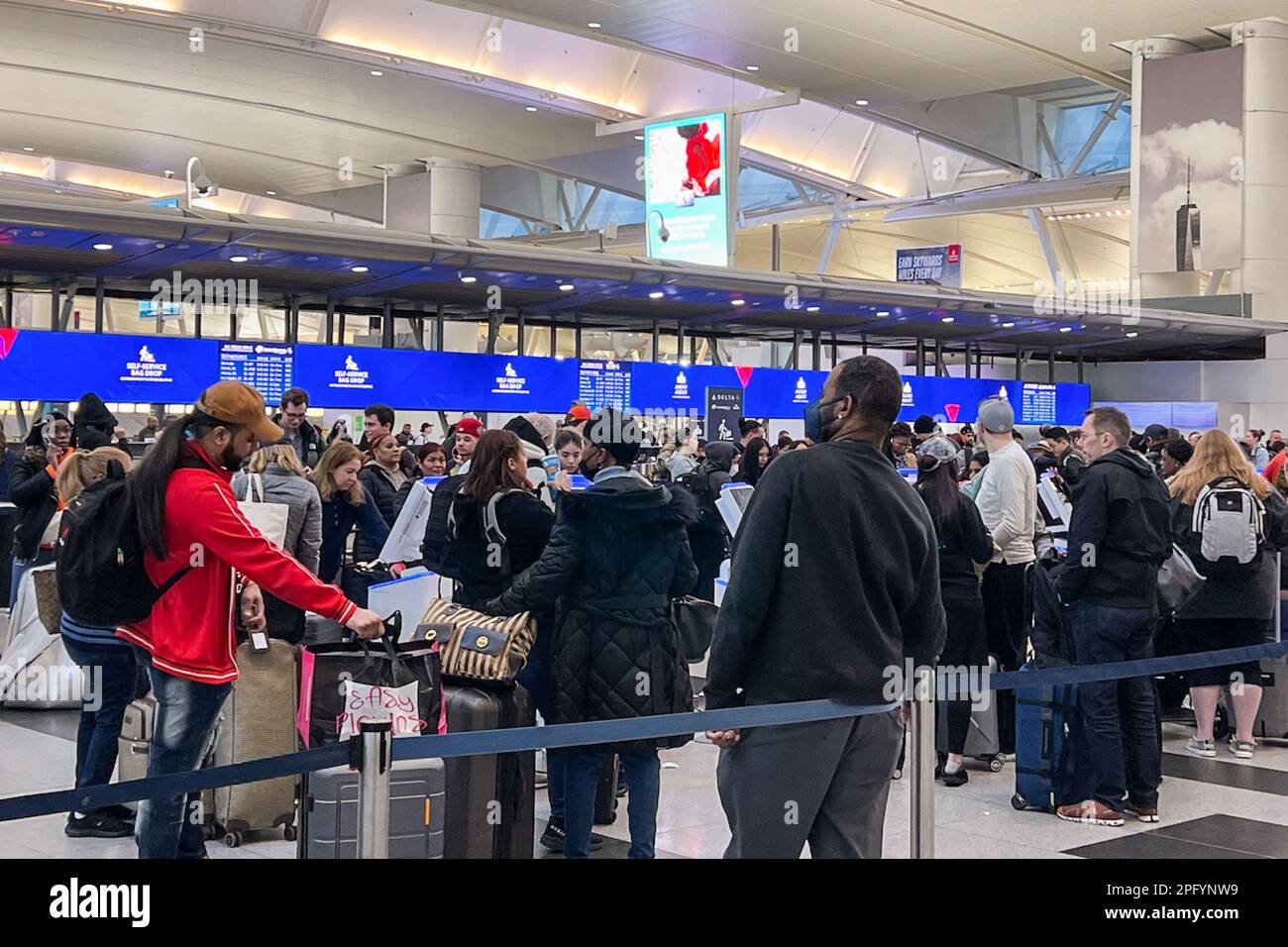 Queens, United States. 08th Mar, 2023. Passengers wait to check in and ...