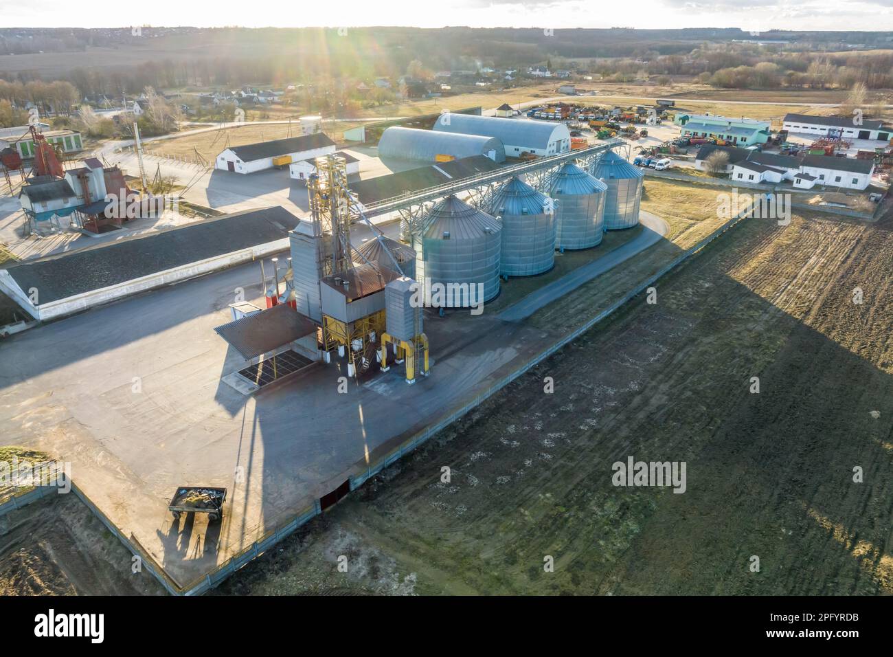 aerial view of agro-industrial complex with silos and grain drying line ...