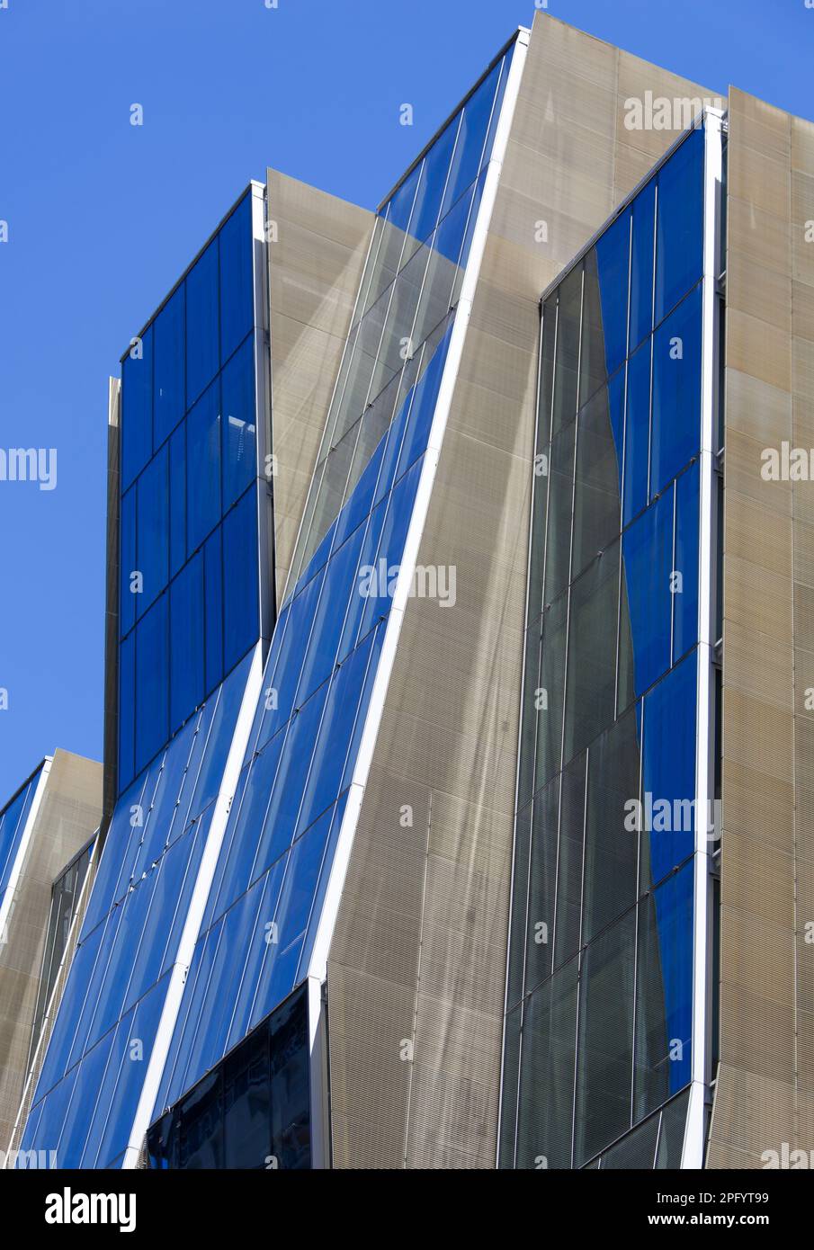 The abstract view of asymmetrical building covered in glass in ...