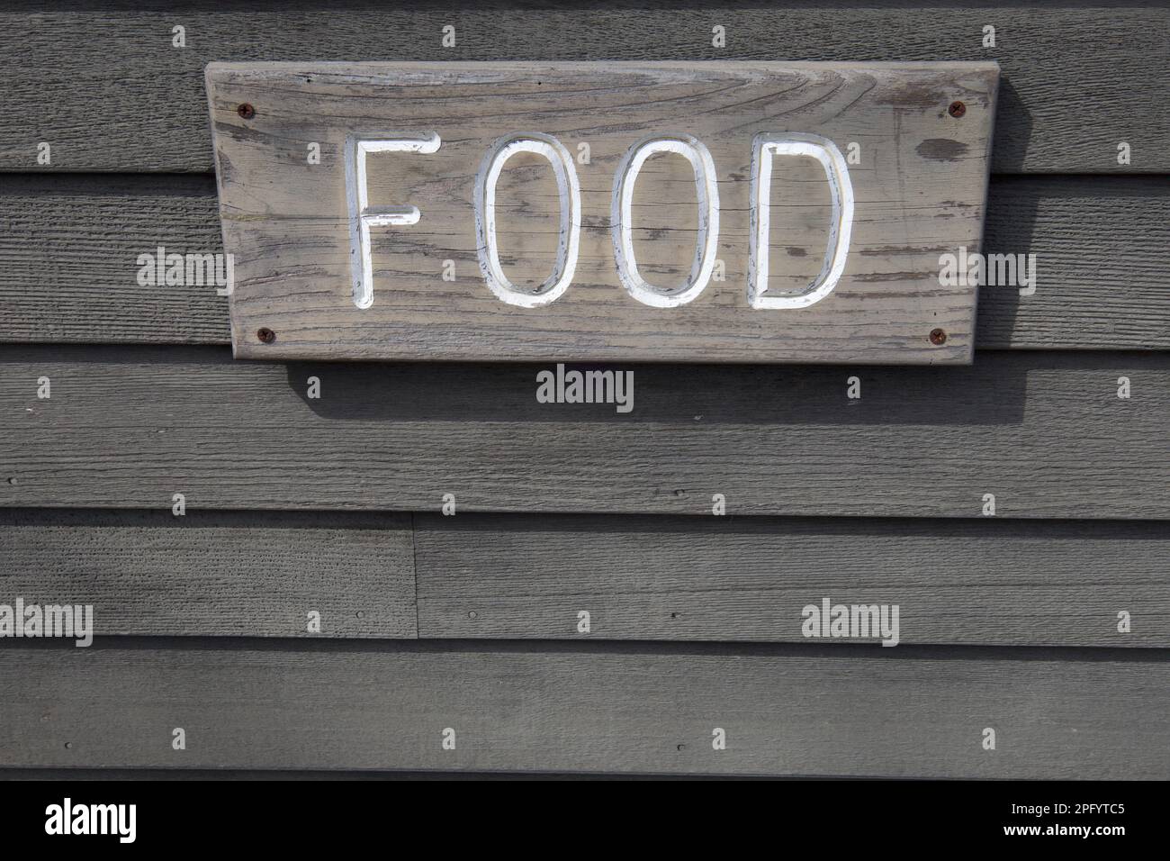 Wooden sign with white lettering that reads: FOOD. Attached to a ...