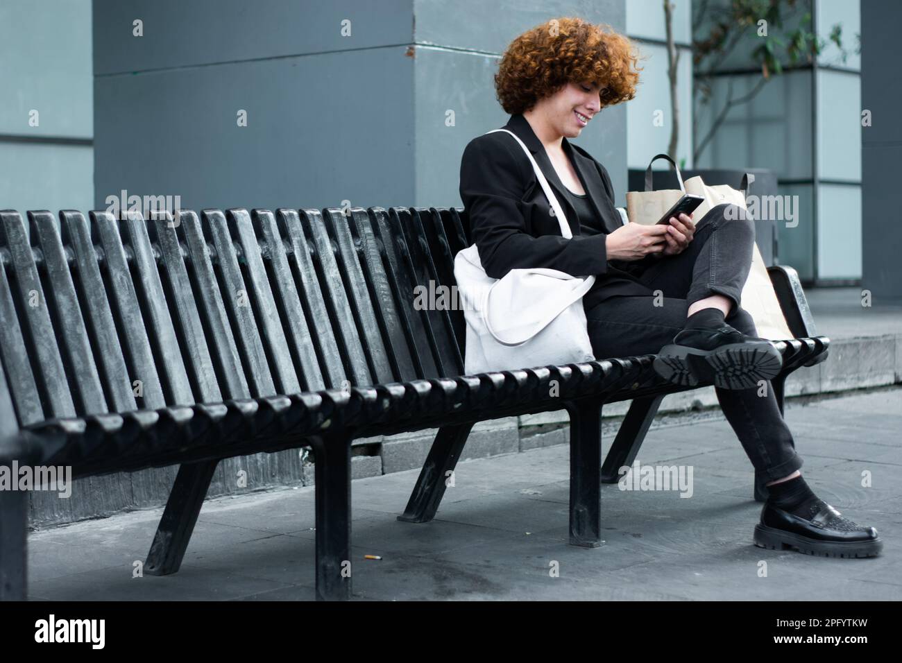 non-binary person is using the smartphone reviewing social media or ...