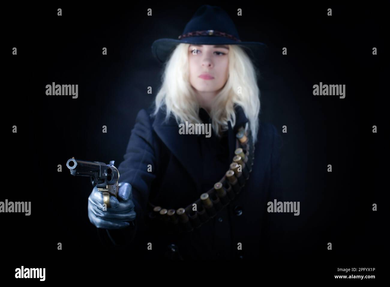Old west blonde girl wearing black hat with revolver handgun on black ...