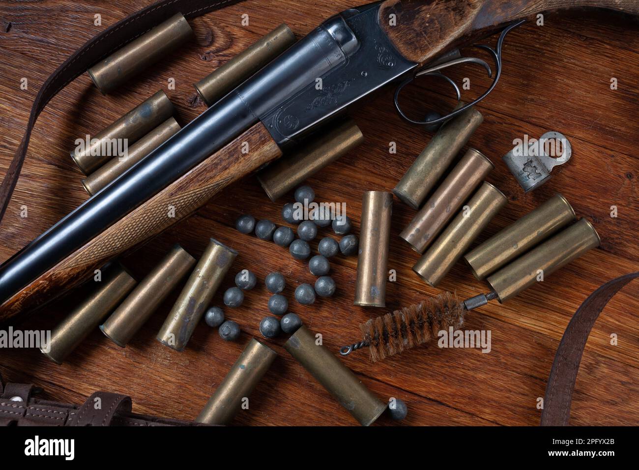Antique 16-gauge break-action smooth-bored shotgun with brass cases and ...