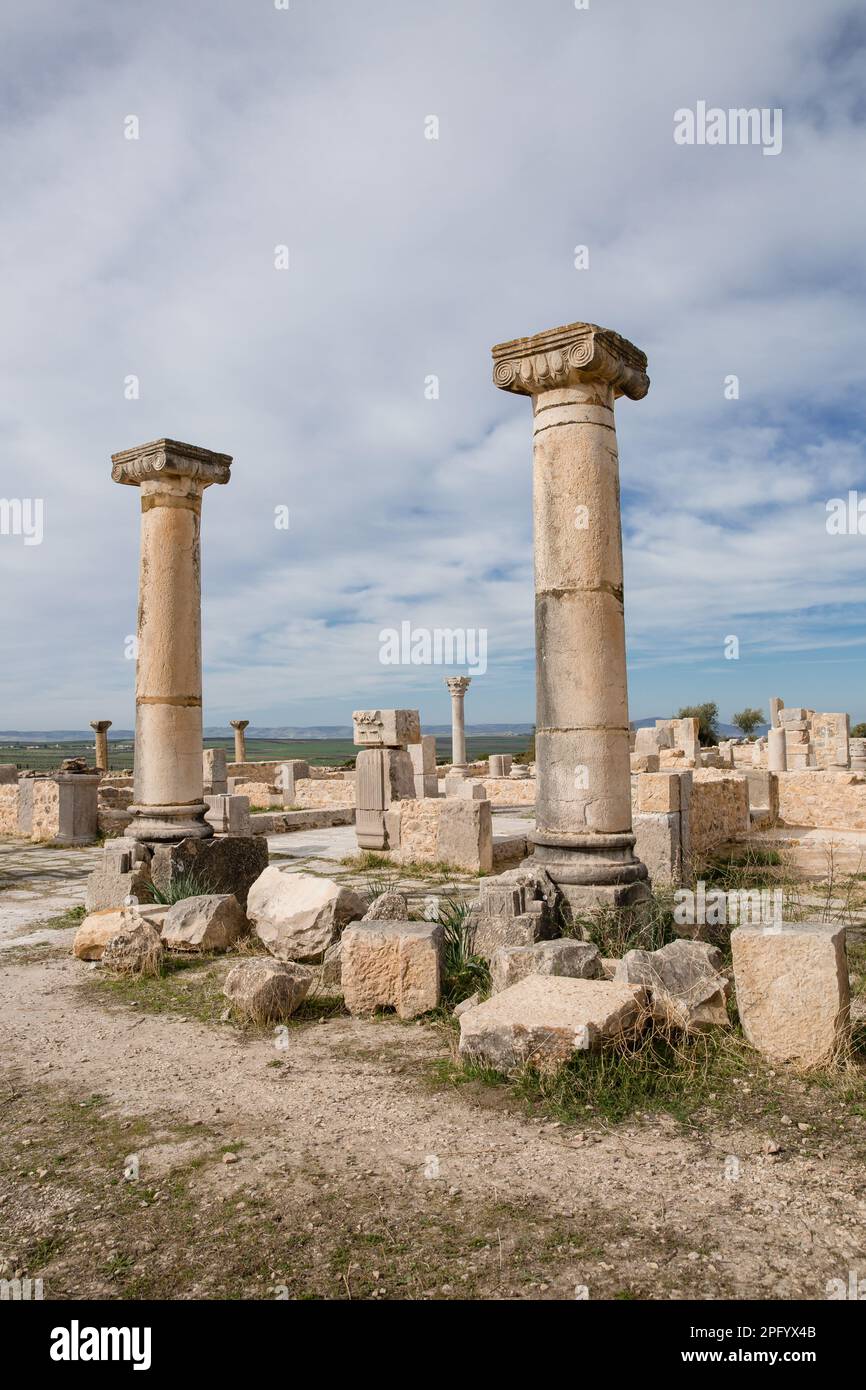 Columns in the clouds in Volubilis Morocco Stock Photo - Alamy