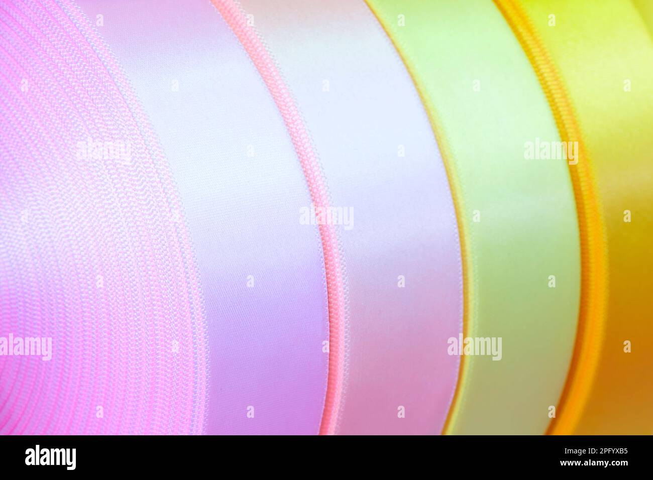 a set of a number of coils of satin ribbons in different colors for the ...