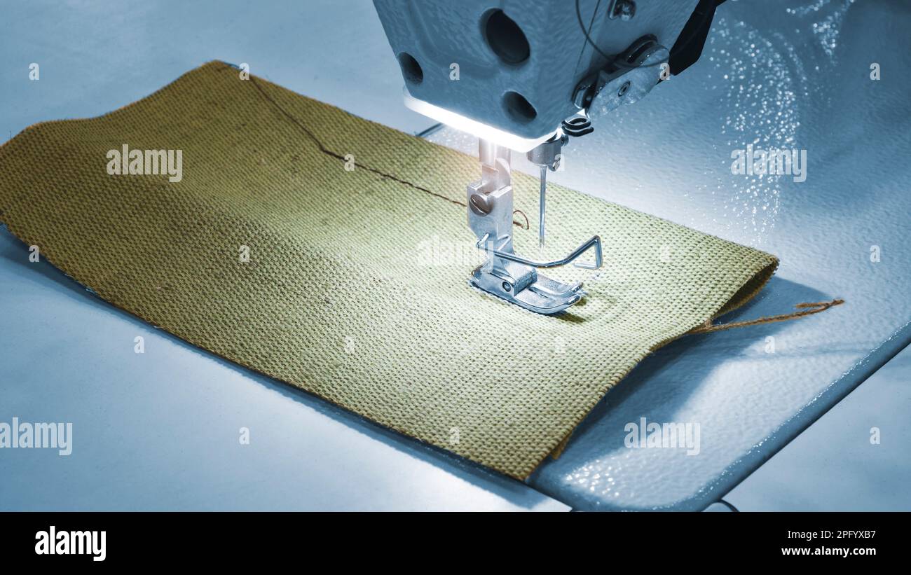 Professional sewing machine and sews garments Stock Photo - Alamy