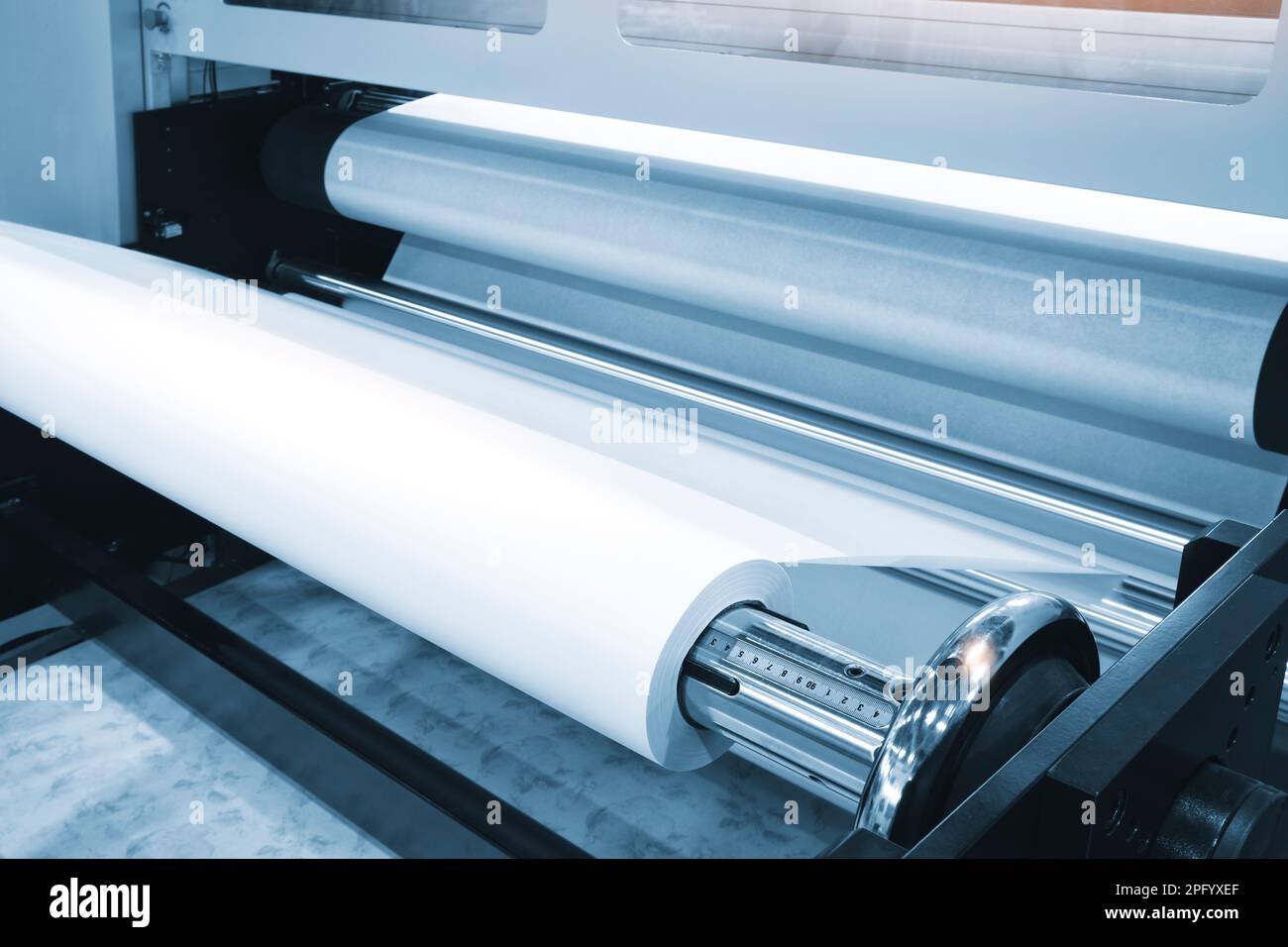 Rolls paper and fabric in wide industrial plotter Stock Photo - Alamy