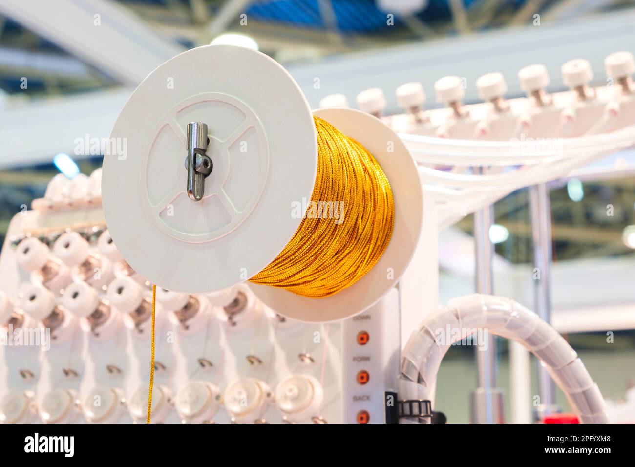 Reels of textile yarn blue thread at industrial weaving manufacturing ...