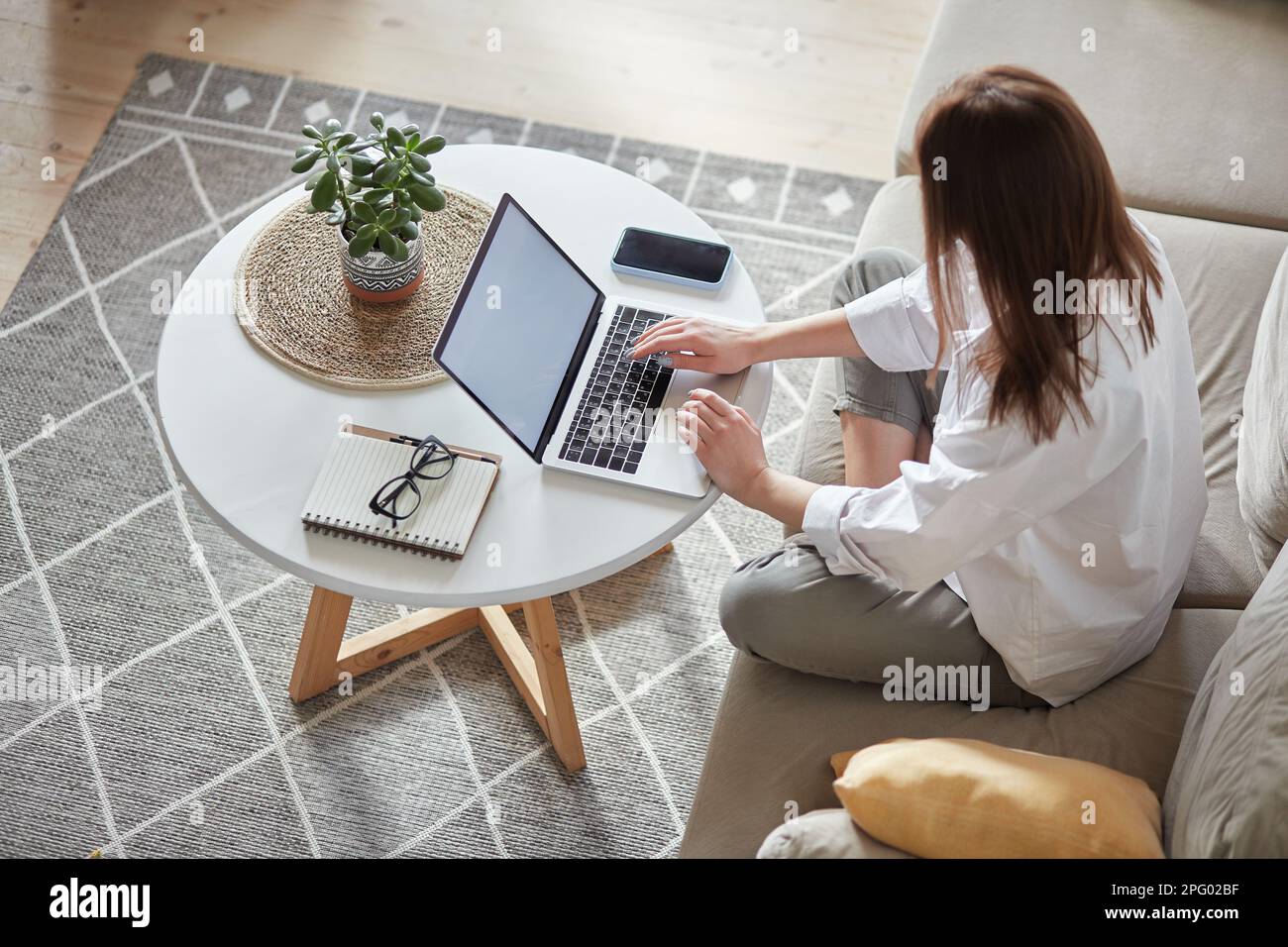 Mockup white screen laptop woman using computer sitting on sofa at home ...
