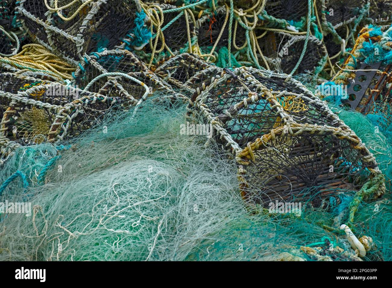 Turquoise fishing net and fish traps, Portmaggee, Ireland Stock Photo ...