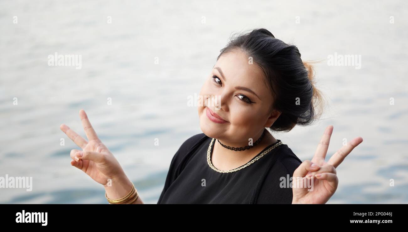 happy young asian woman making double V sign with both hands Stock ...
