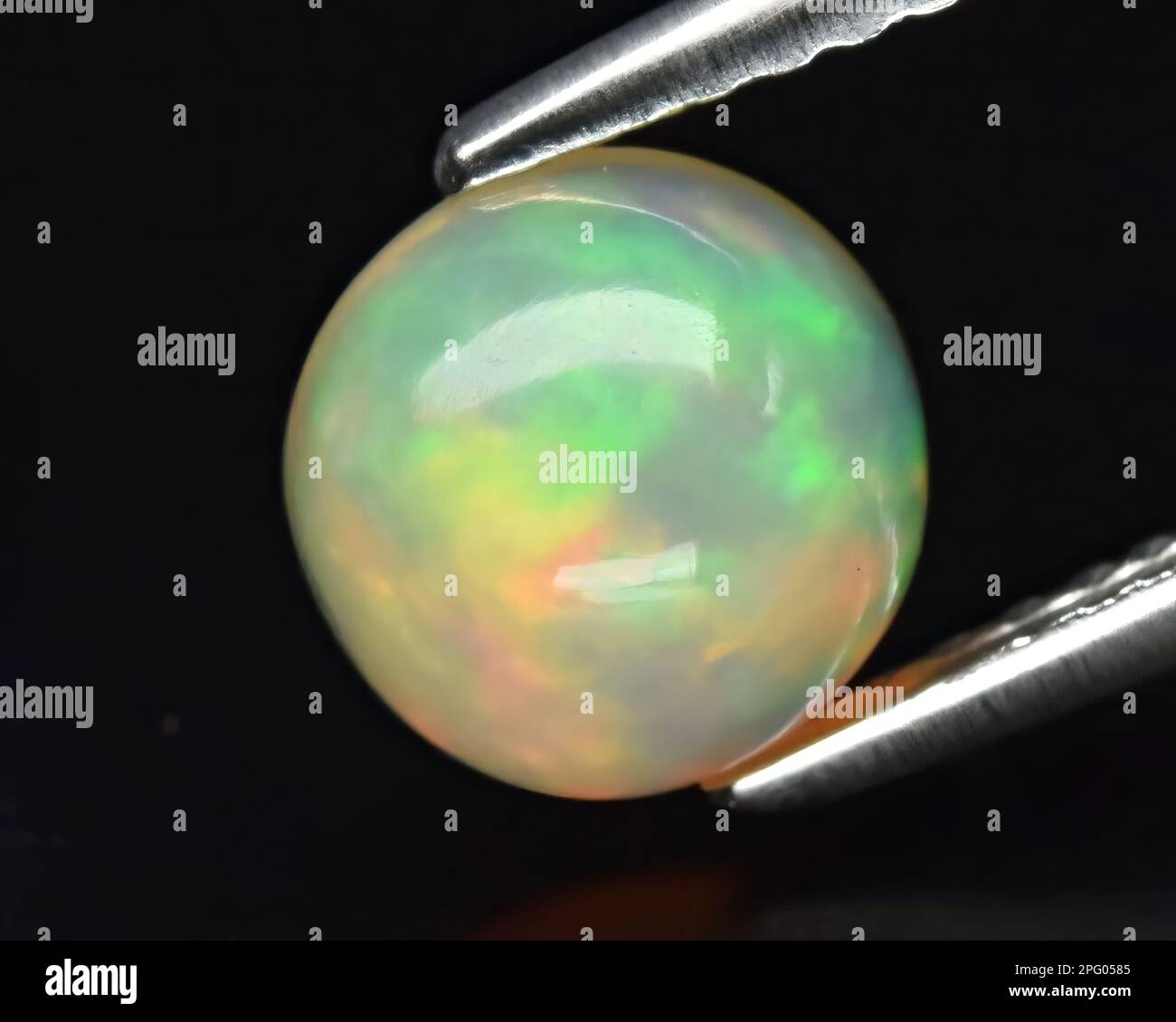 Natural precious stone noble opal on a black background Stock Photo - Alamy