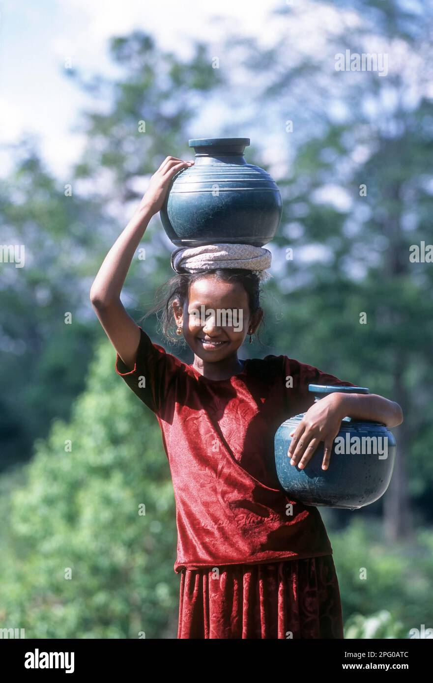 Indian girl carrying water in the jug, Kabini, Karnataka, India Stock ...