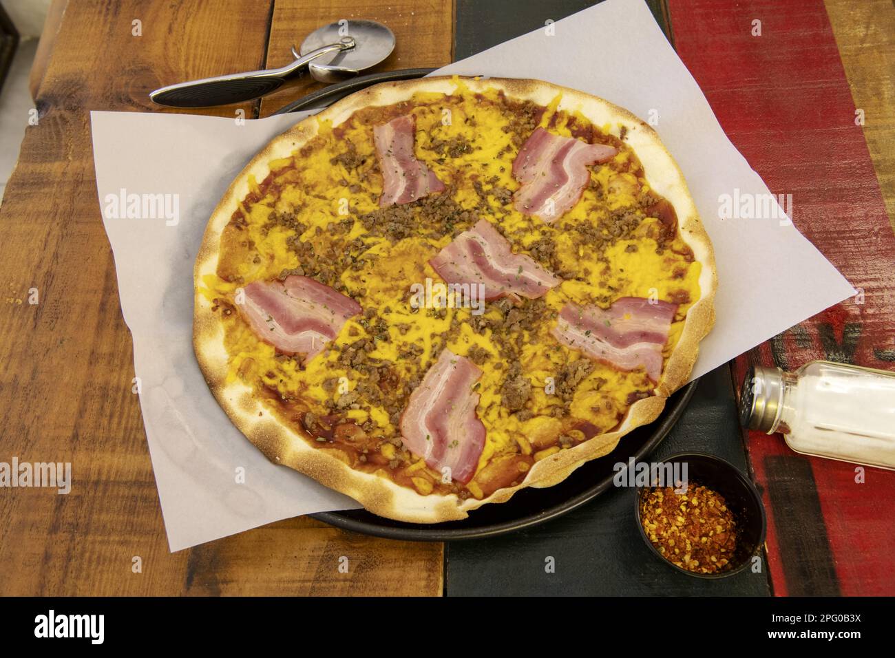 A wonderful medium thin crust pizza with bacon, various meats, cheddar ...