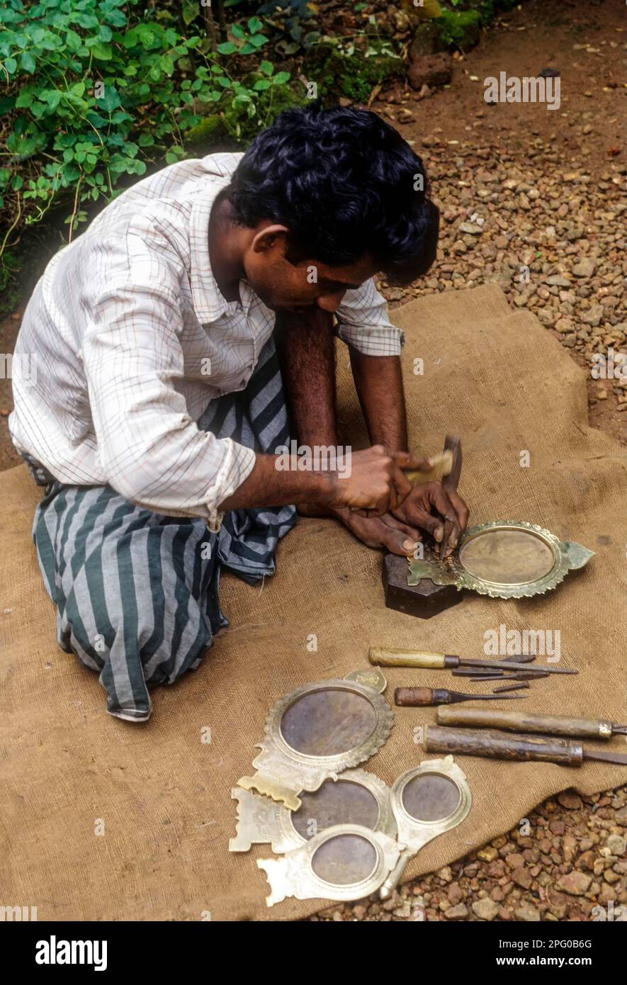 An artisan making Aranmula kannadi metal mirror at Aranmula, Kerala ...
