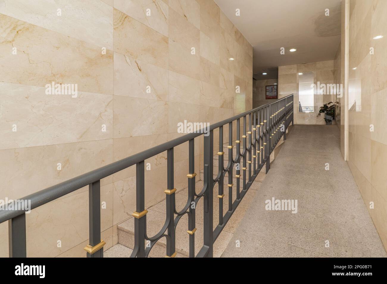 Access ramp to residential building with metal railing with gold ...