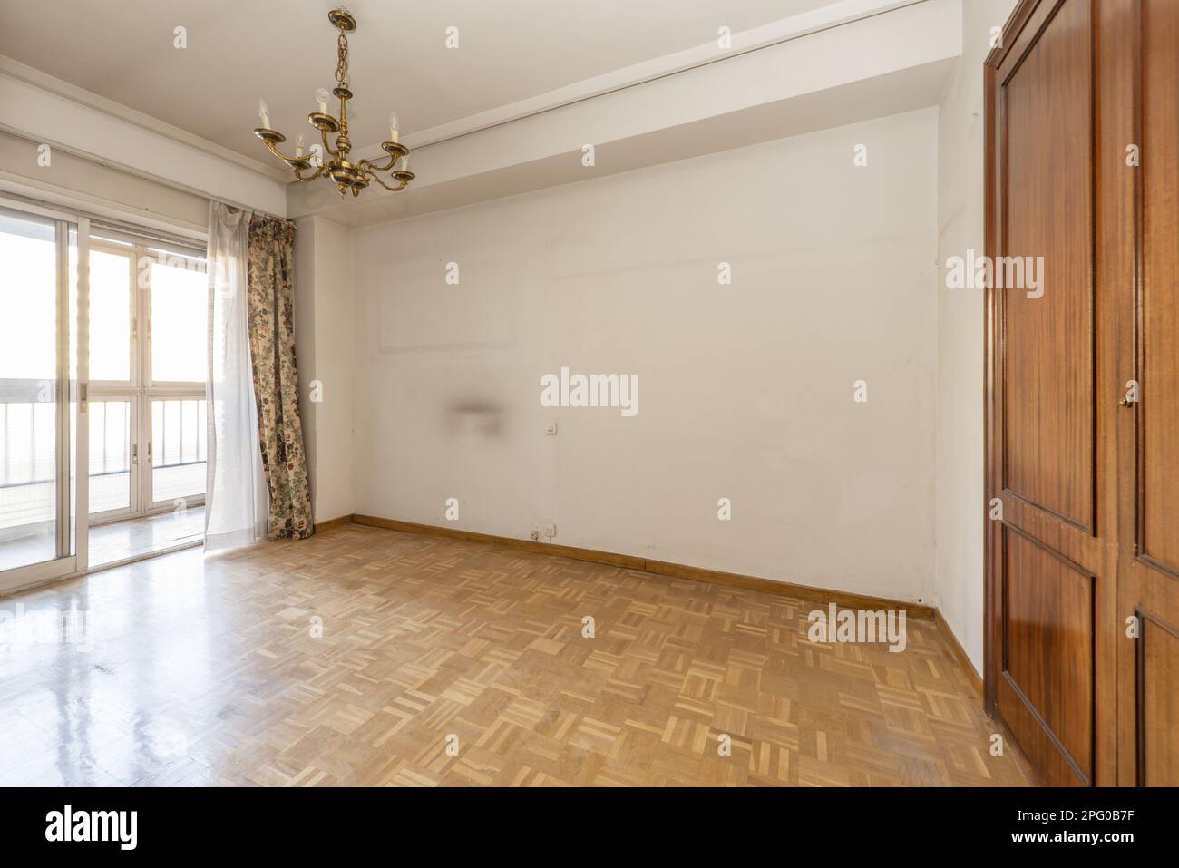 Empty living room of a house with access to a terrace closed with ...