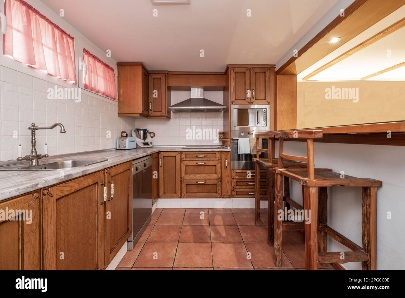 Kitchen with rustic-style wooden furniture with integrated appliances ...