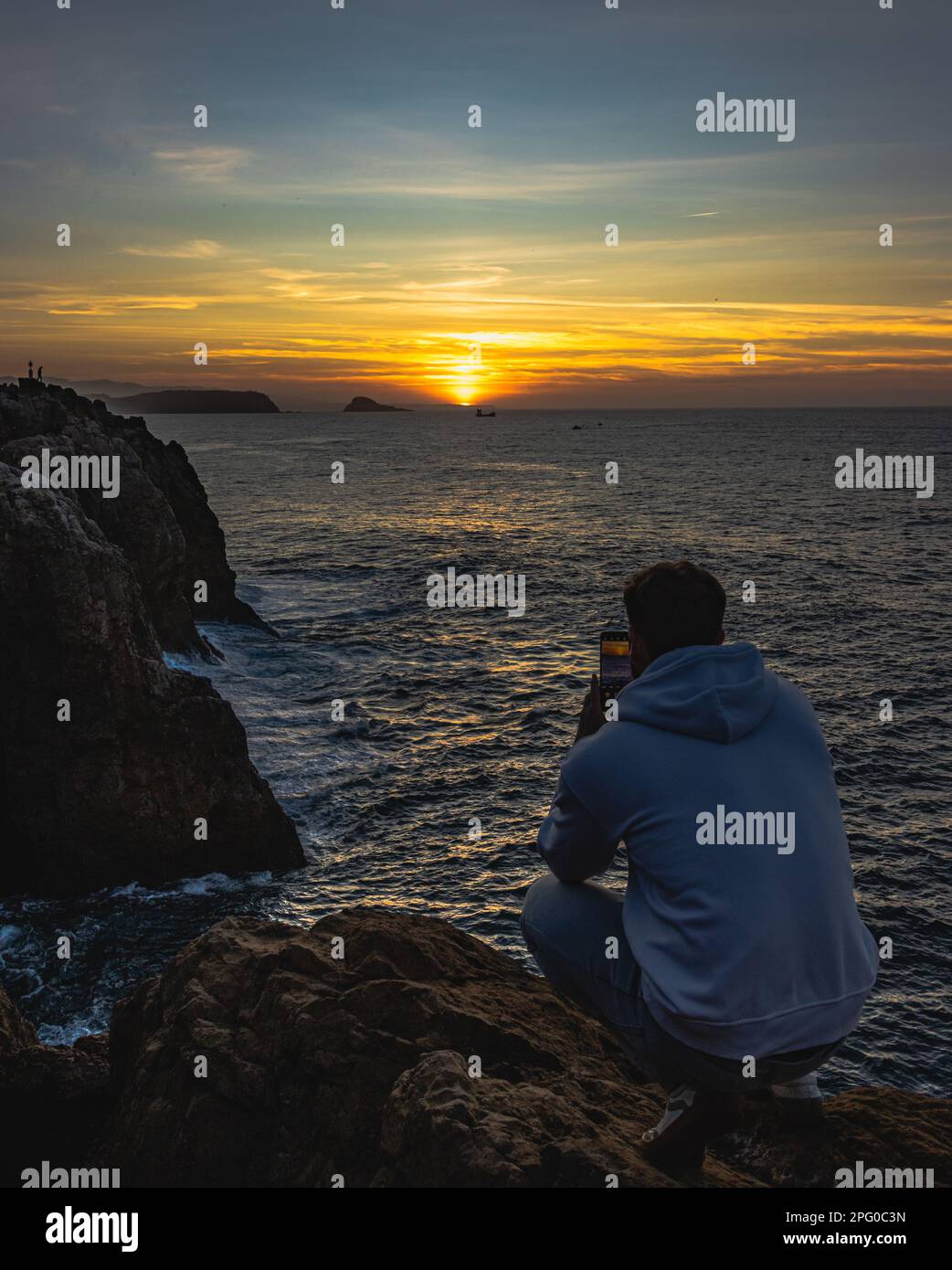 boy taking a picture of a beautiful sunset Stock Photo - Alamy