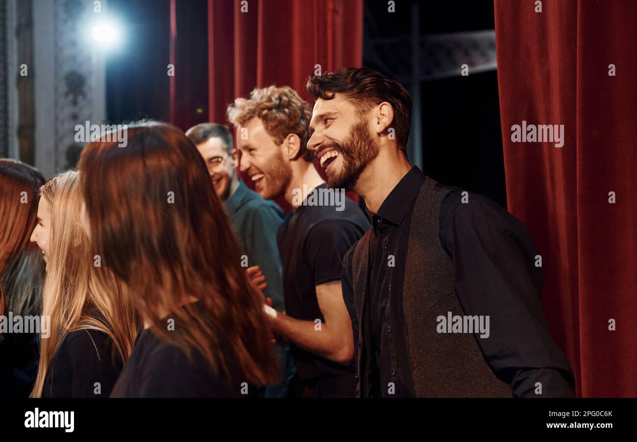 Working together. Group of actors in dark colored clothes on rehearsal ...