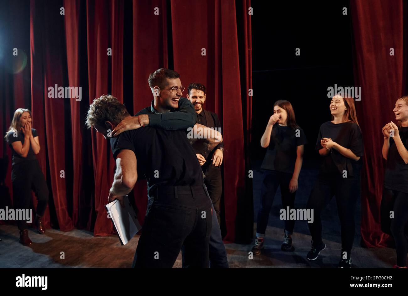 Fight scene. Group of actors in dark colored clothes on rehearsal in ...