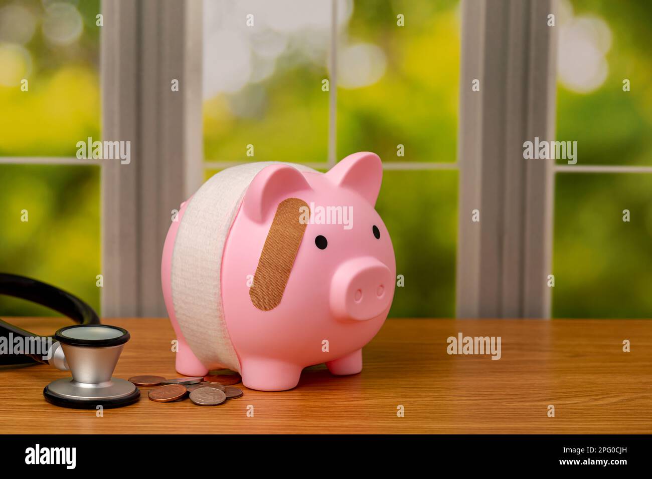 Piggy bank with bandage and stethoscope. Health care costs, medical ...
