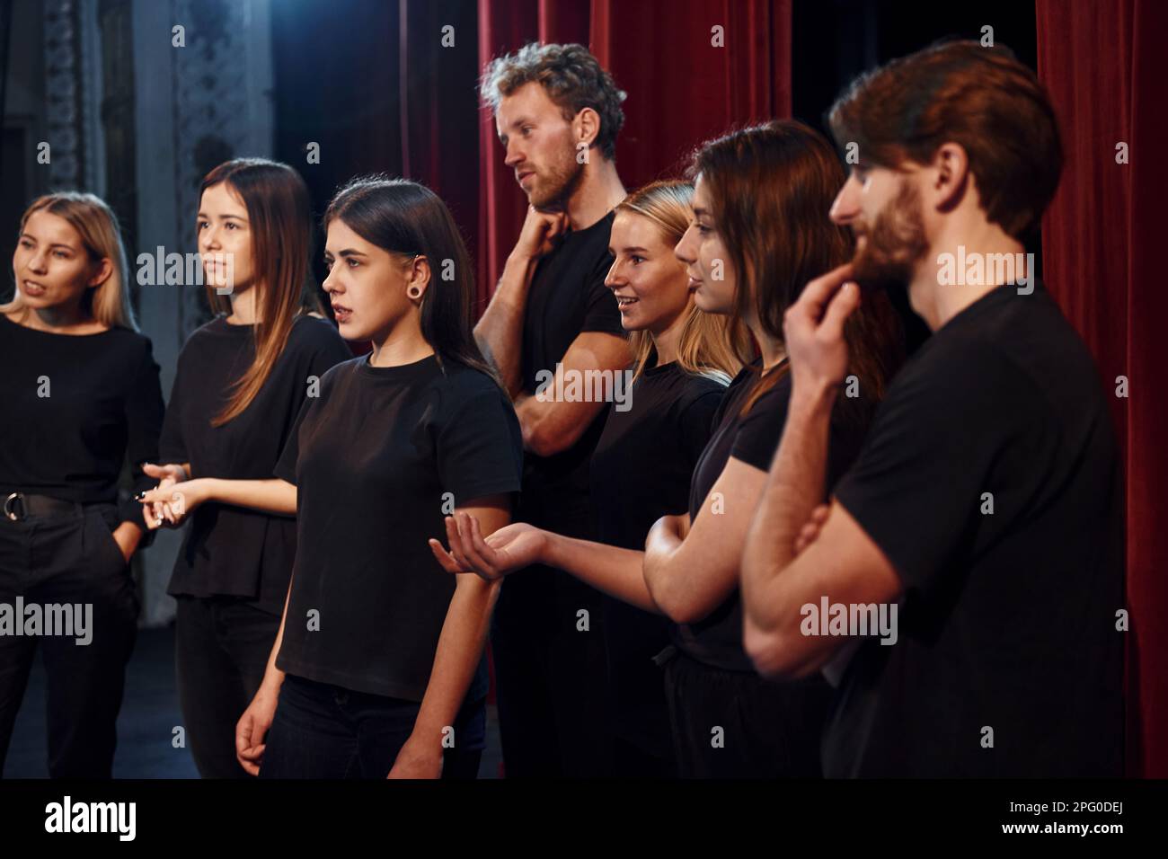Side view. Group of actors in dark colored clothes on rehearsal in the ...