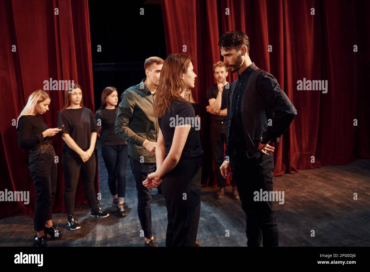 Eye contact practice. Group of actors in dark colored clothes on ...
