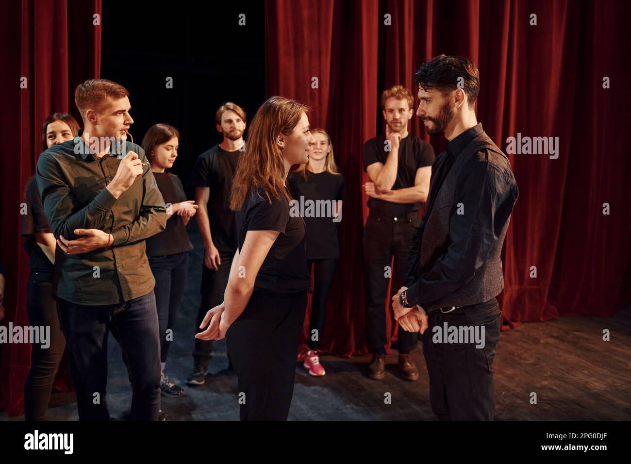 Eye contact practice. Group of actors in dark colored clothes on ...