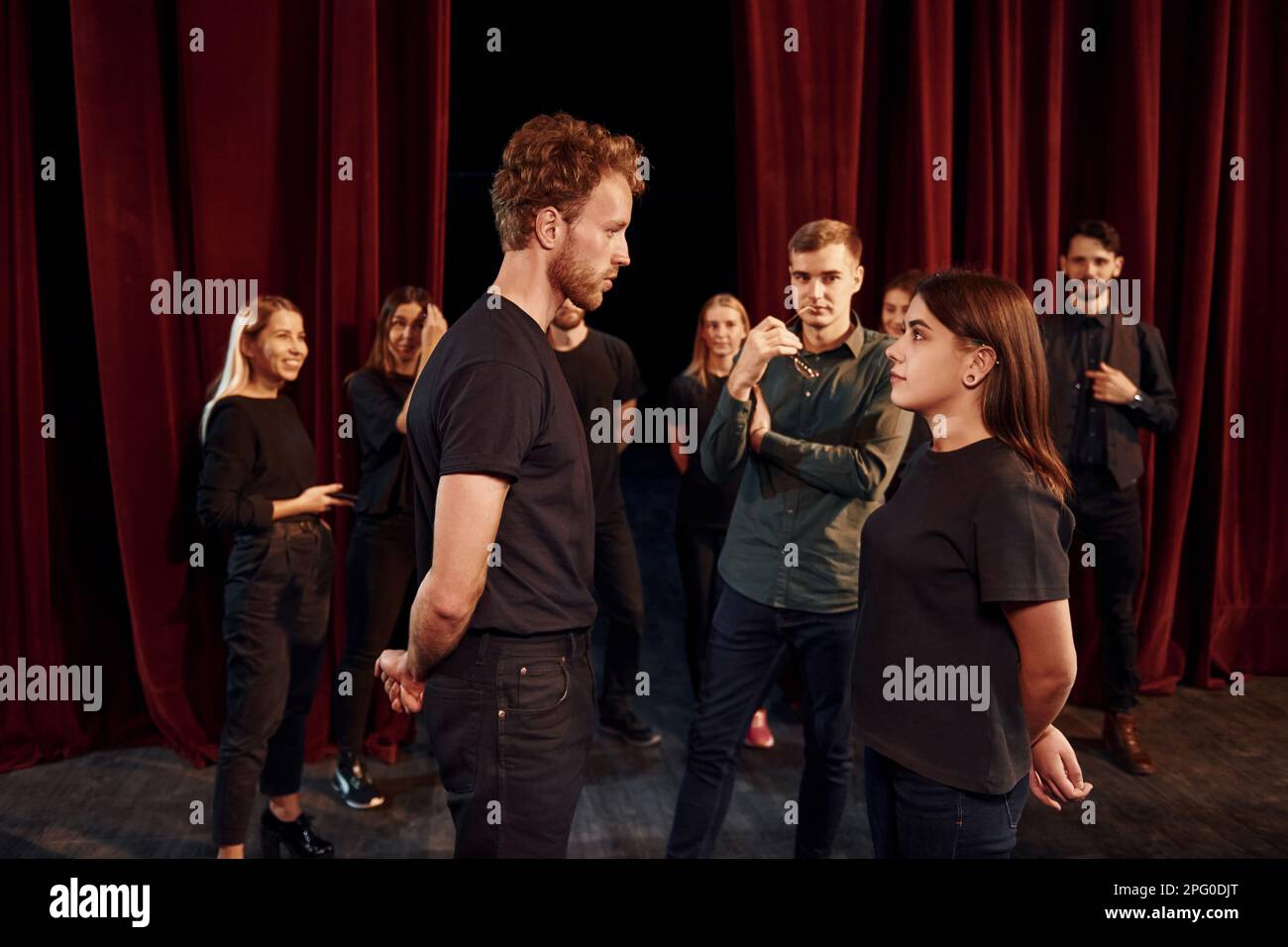 Eye contact practice. Group of actors in dark colored clothes on ...