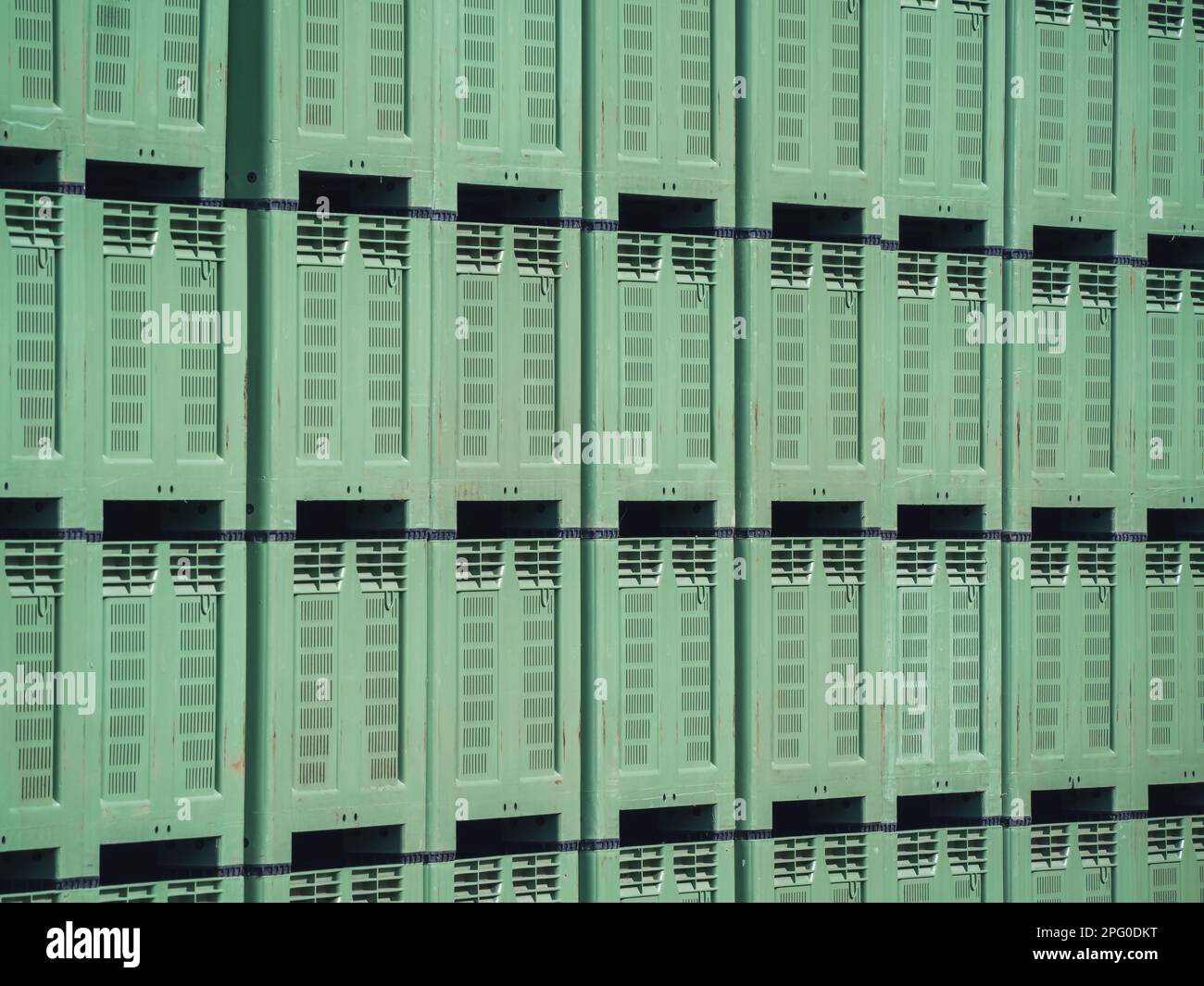 Big green plastic crates for fruits are stacked and waiting to be ...