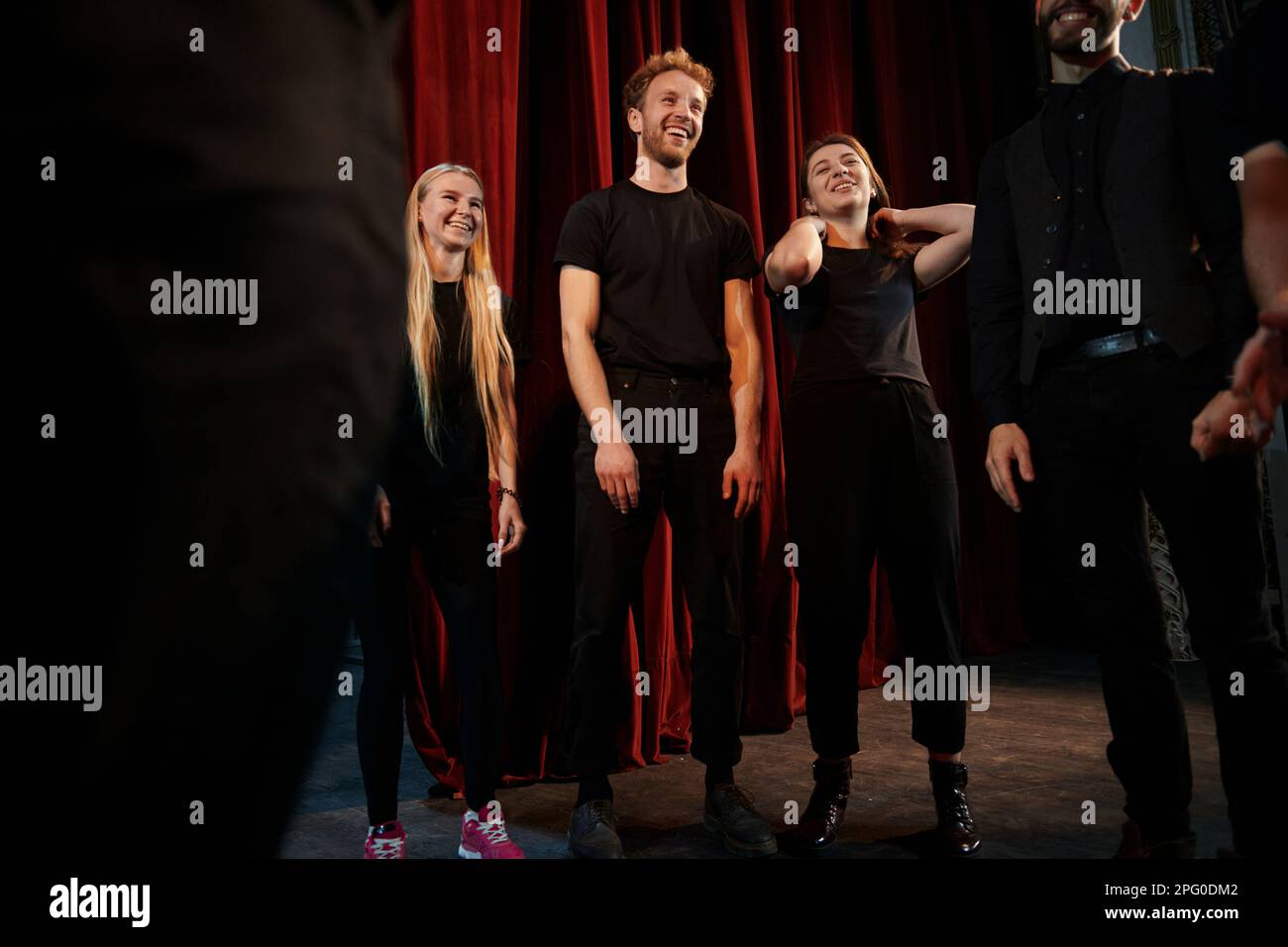Practice in progress. Group of actors in dark colored clothes on ...