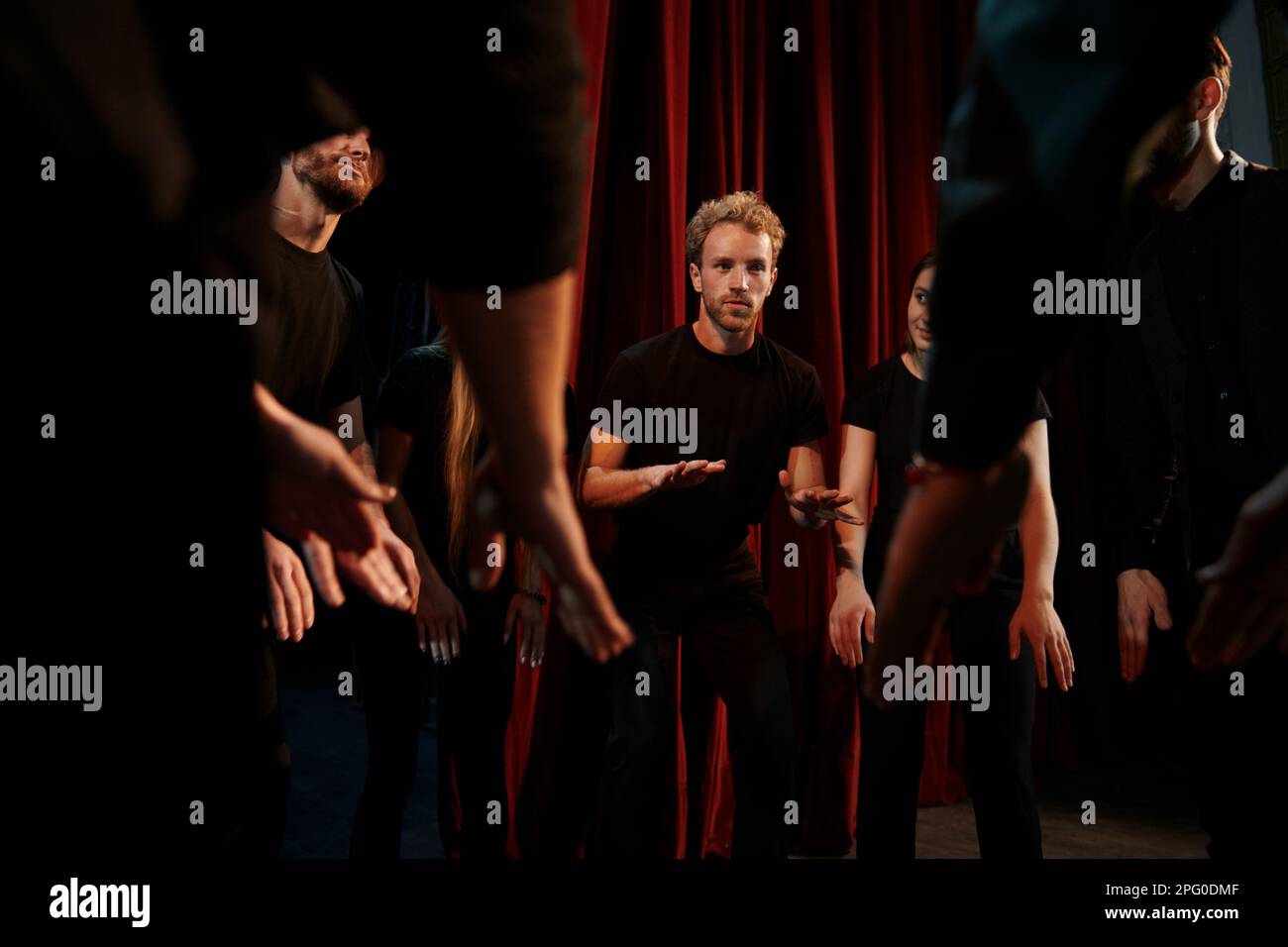 Practice in progress. Group of actors in dark colored clothes on ...