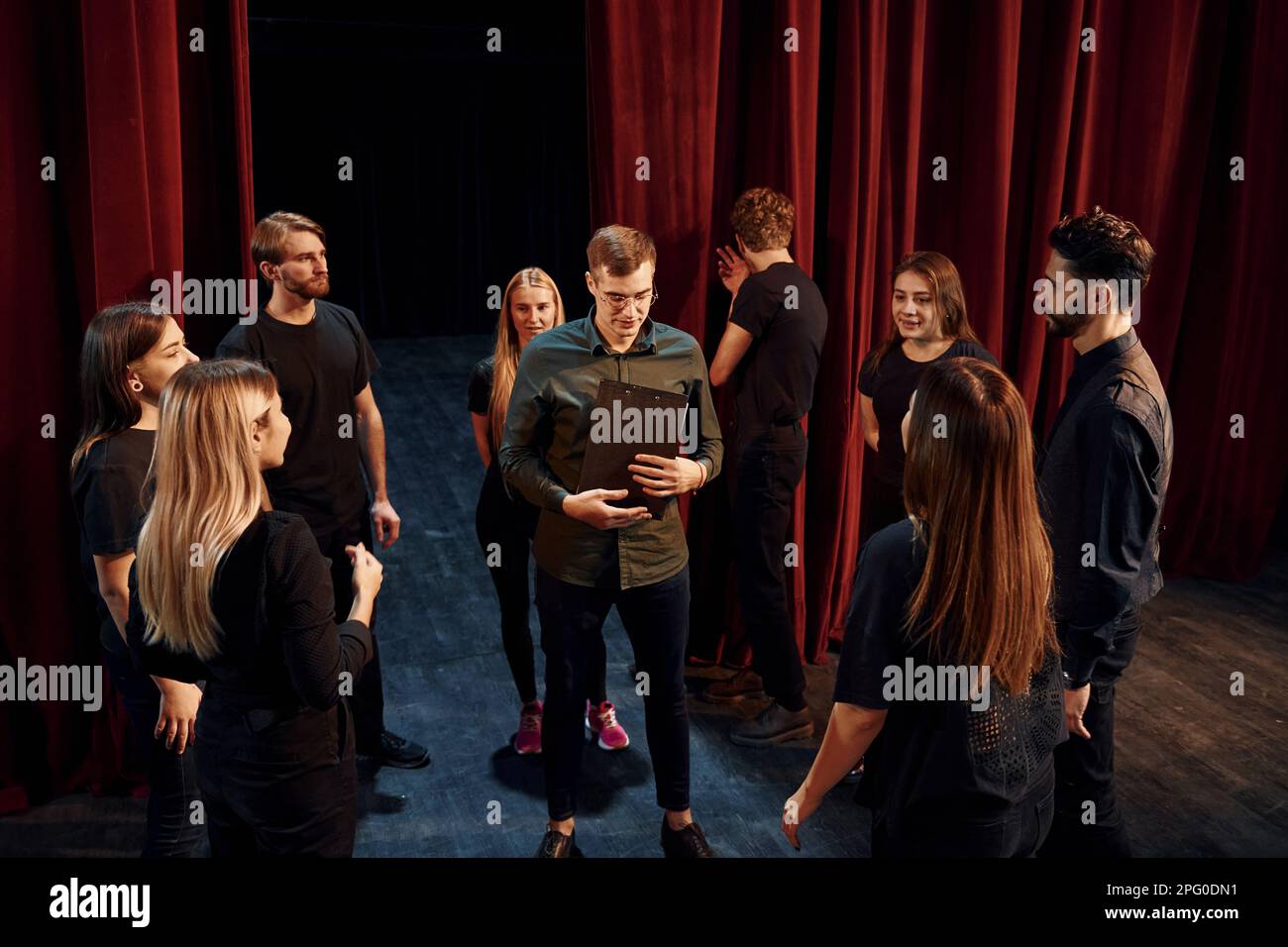 Practice in progress. Group of actors in dark colored clothes on ...