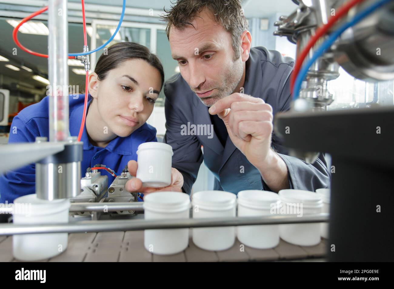 engineer showing apprentice how to use cnc tool making machine Stock ...