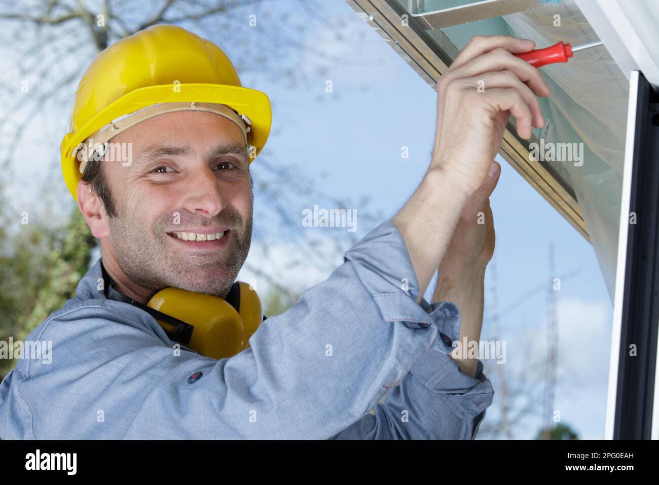 worker screws a window outdoors Stock Photo - Alamy