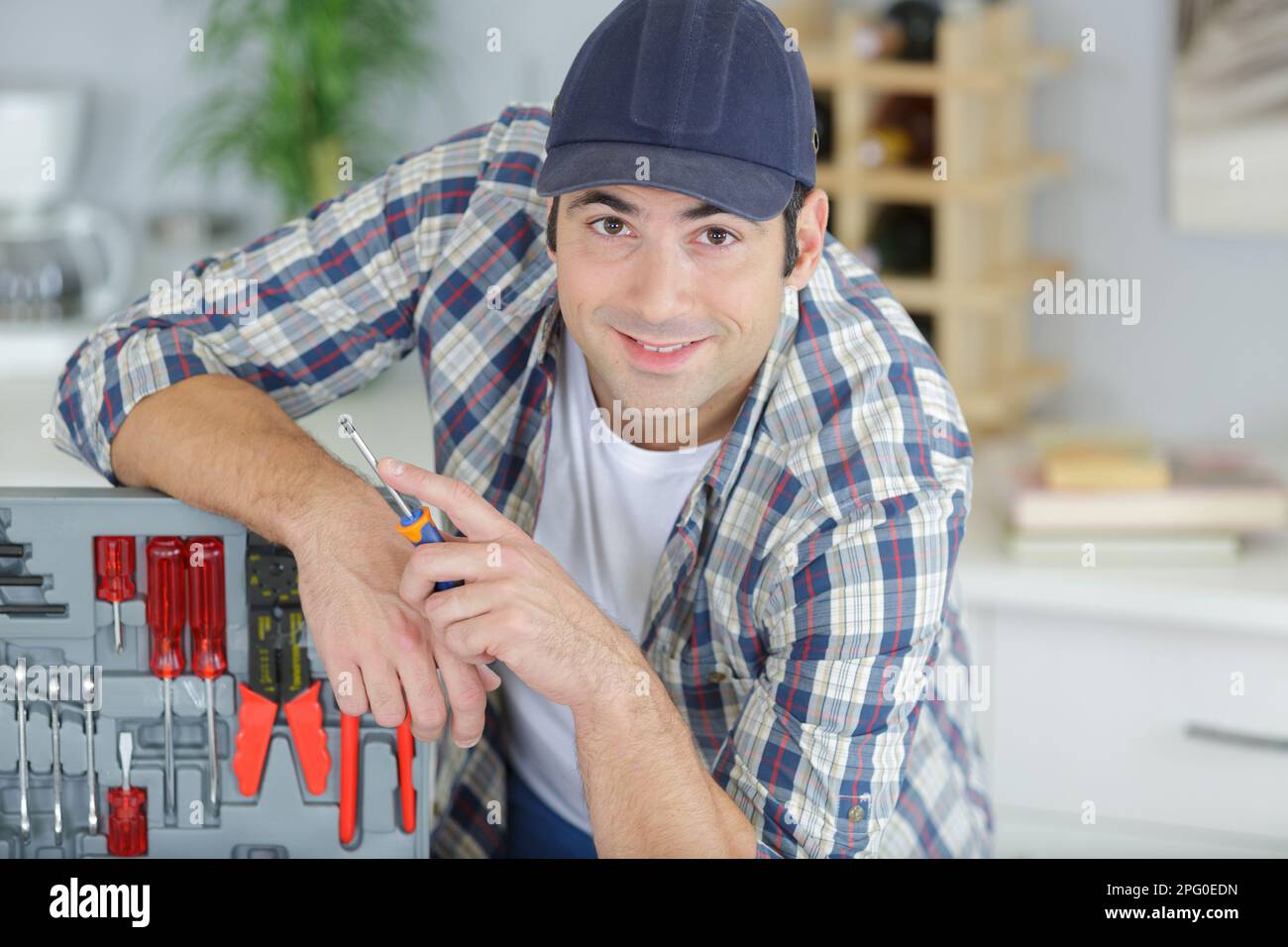 happy man with tools in a box Stock Photo - Alamy